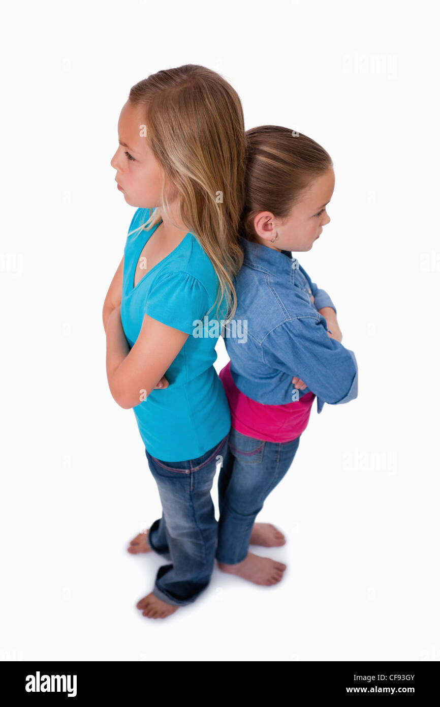 Portrait of girls standing back to back Stock Photo - Alamy