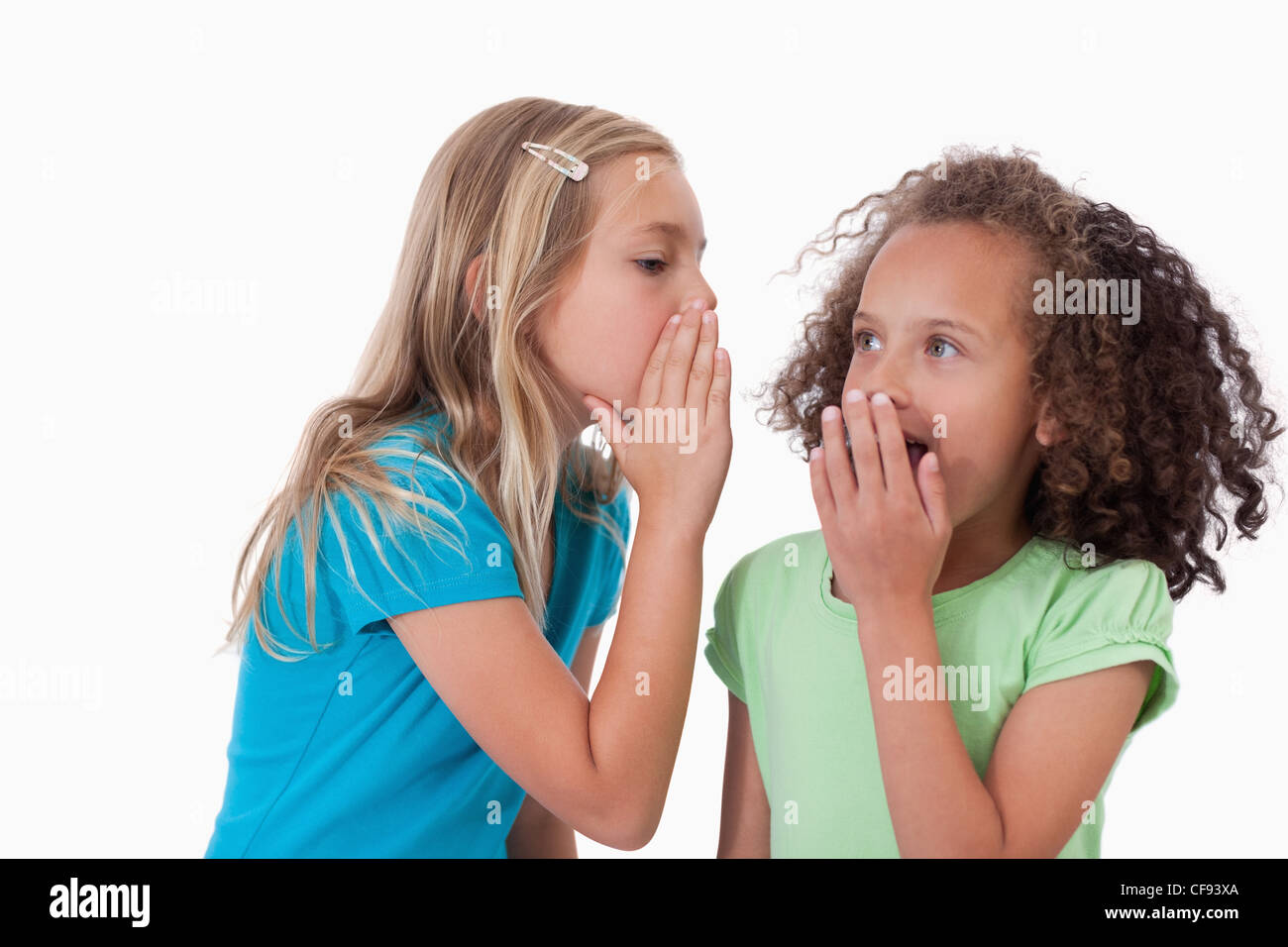 Cute girl whispering a secret to her friend Stock Photo - Alamy