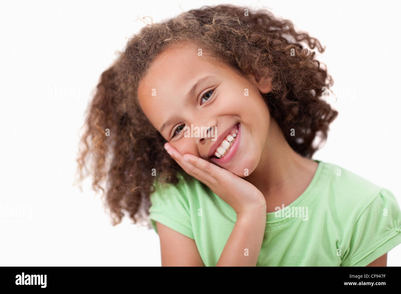 Cute girl with her hand on her cheek Stock Photo - Alamy
