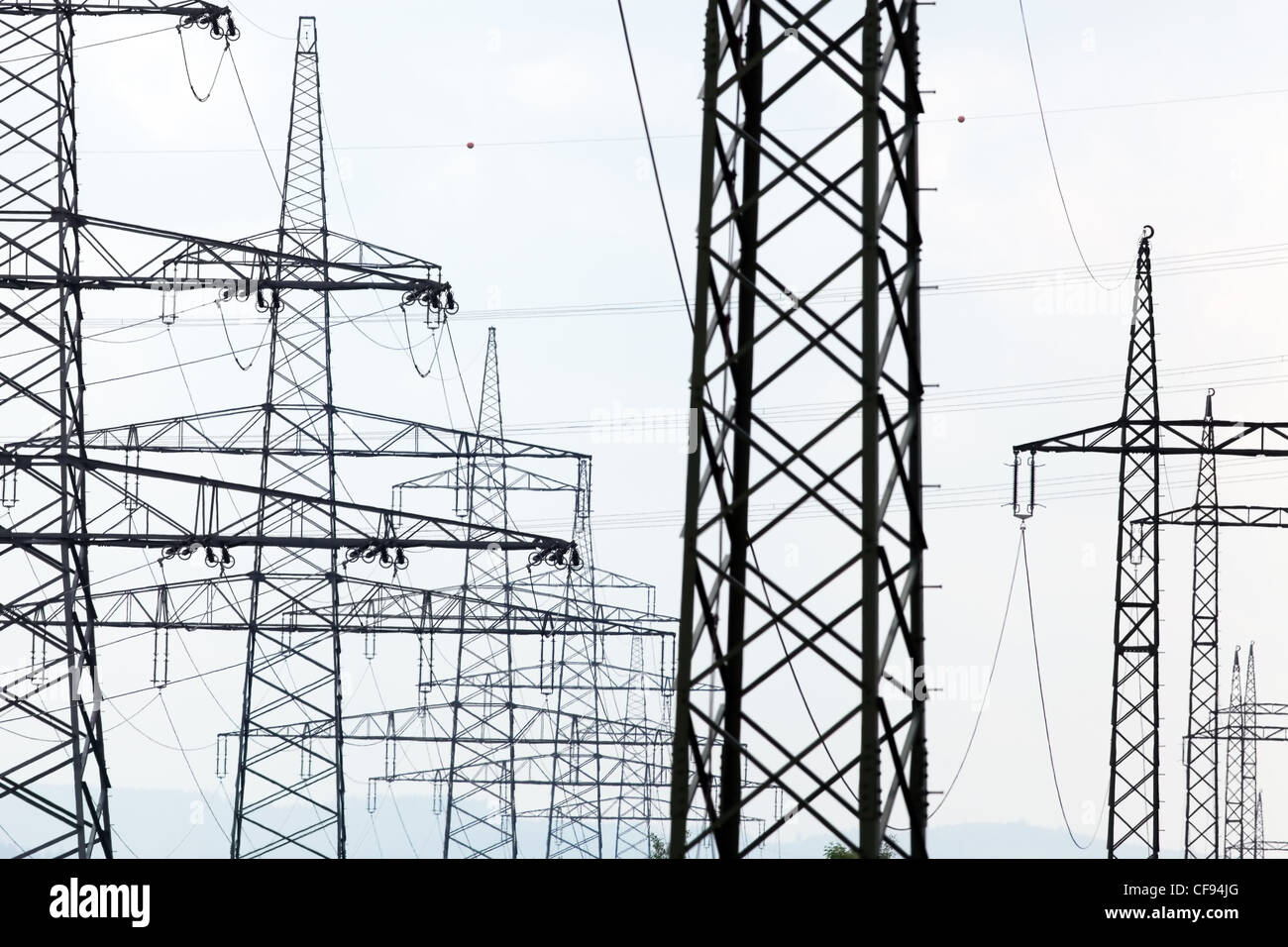 many electricity pylons of a power line. pylons in front of the open ...
