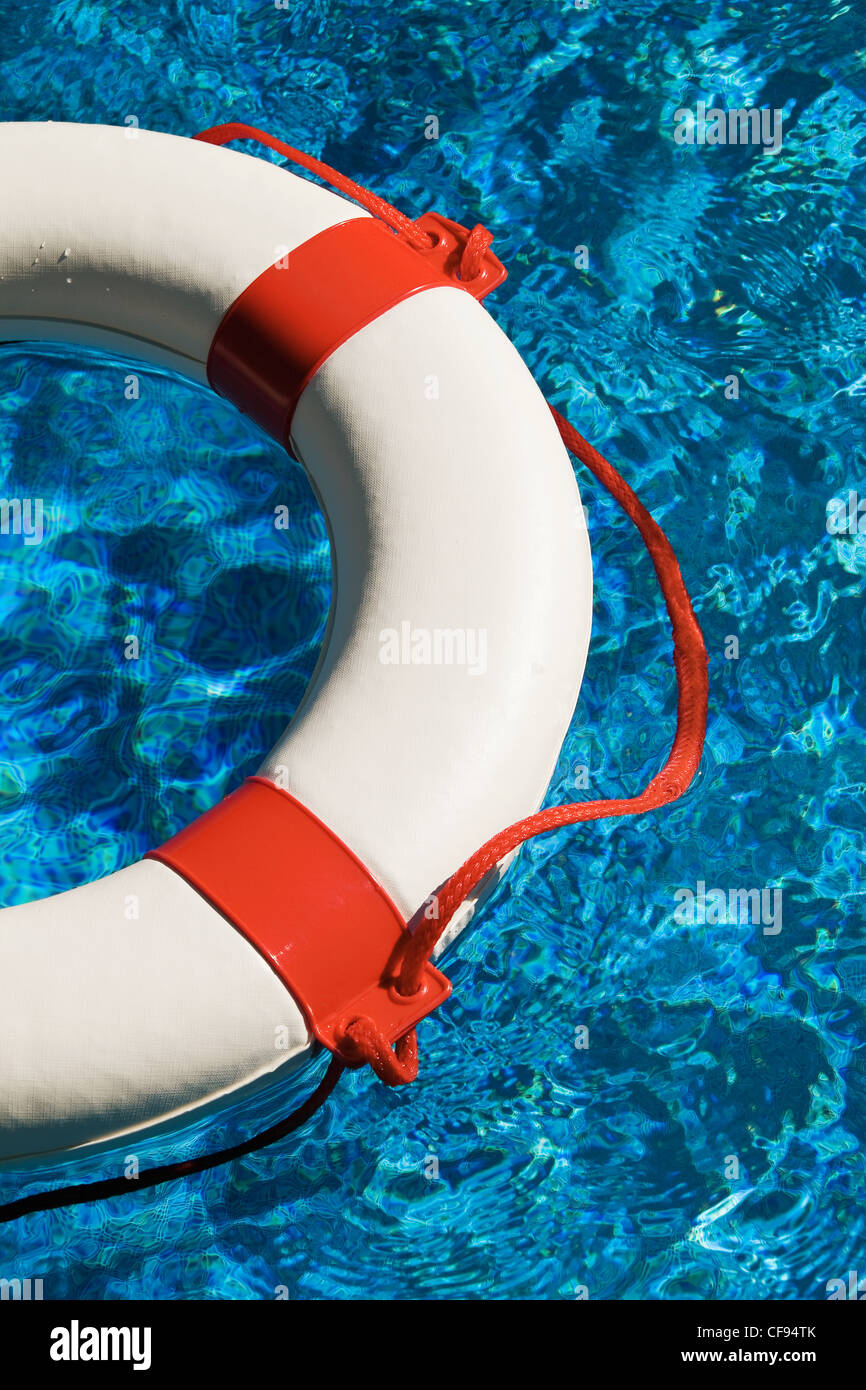 a white life ring with a red stripe in the blue water Stock Photo - Alamy