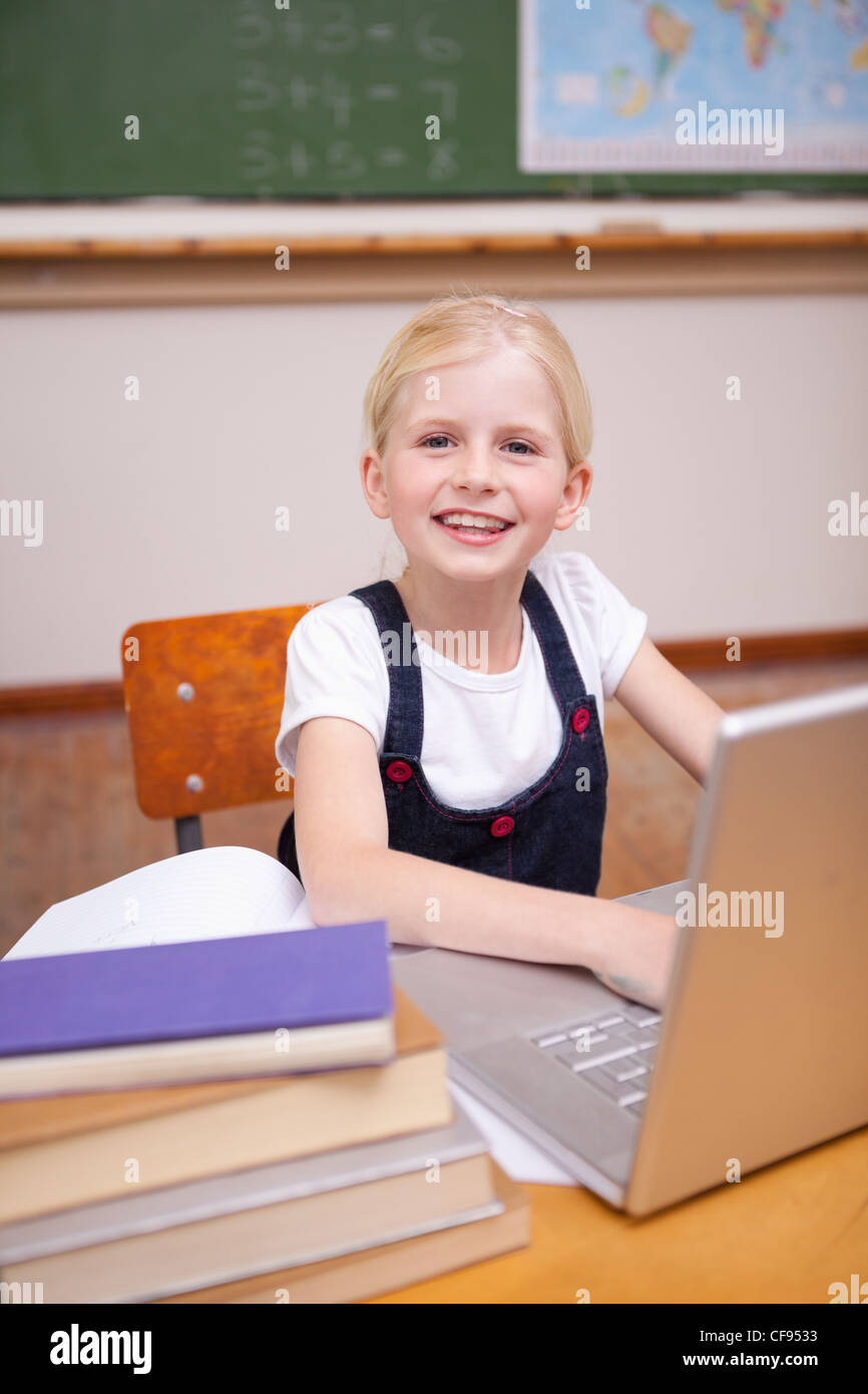 Portrait of a little girl using a notebook Stock Photo - Alamy