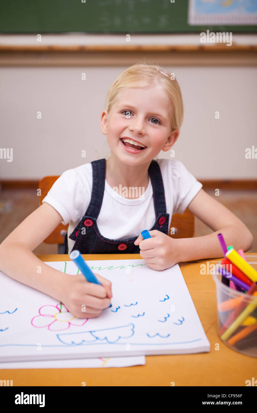 Portrait of a smiling girl drawing Stock Photo - Alamy