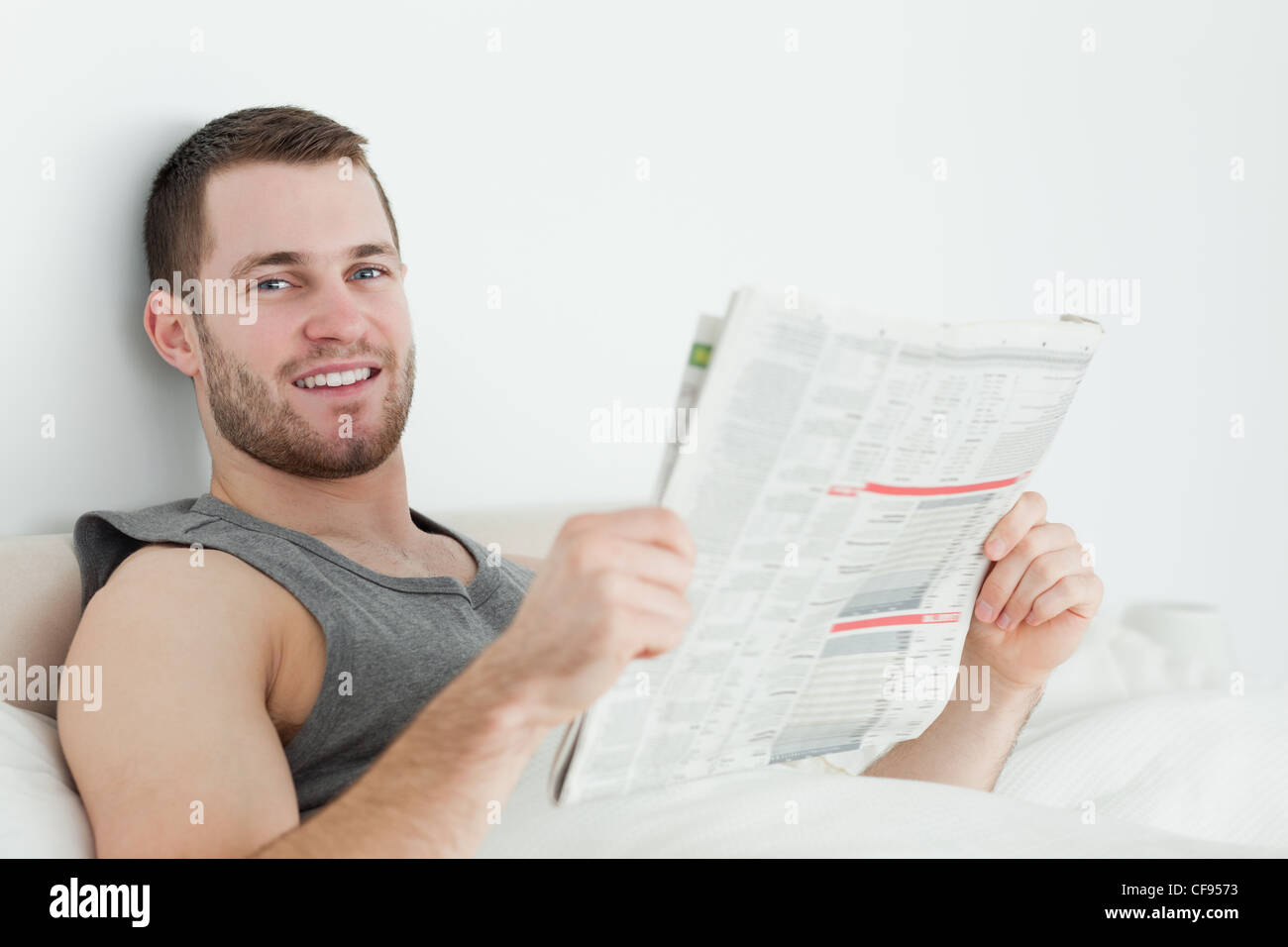 Handsome man reading a newspaper Stock Photo - Alamy