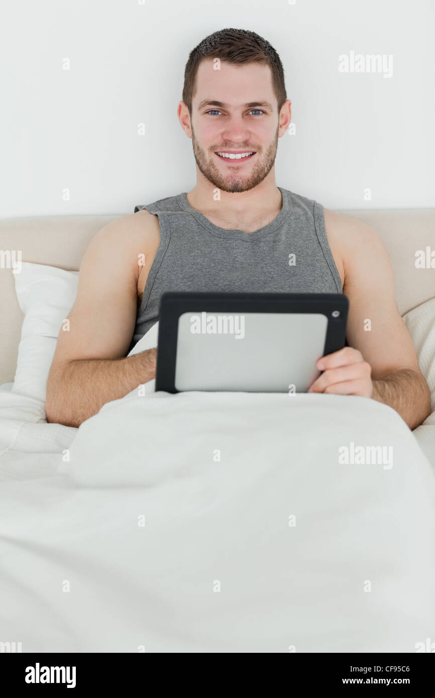 Portrait of a happy man using a tablet computer Stock Photo - Alamy