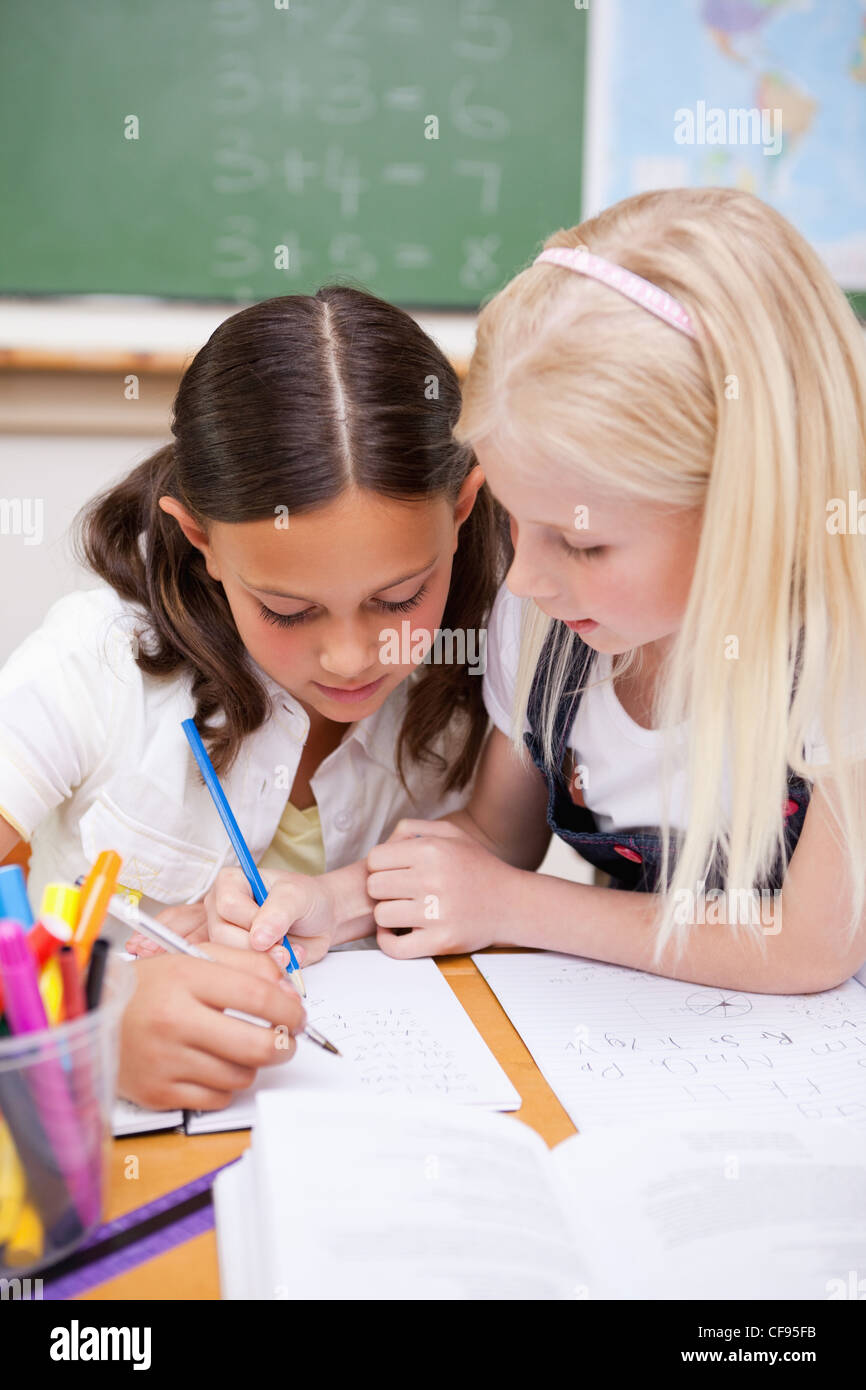 Portrait of pupils working together on an assignment Stock Photo - Alamy