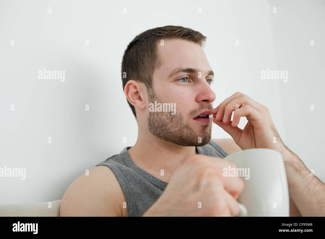 Man taking a pill Stock Photo - Alamy