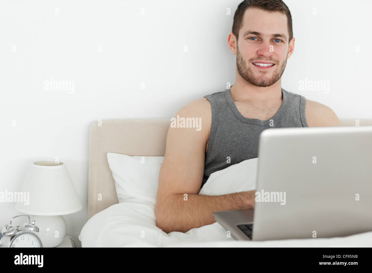 Young man using a laptop Stock Photo - Alamy
