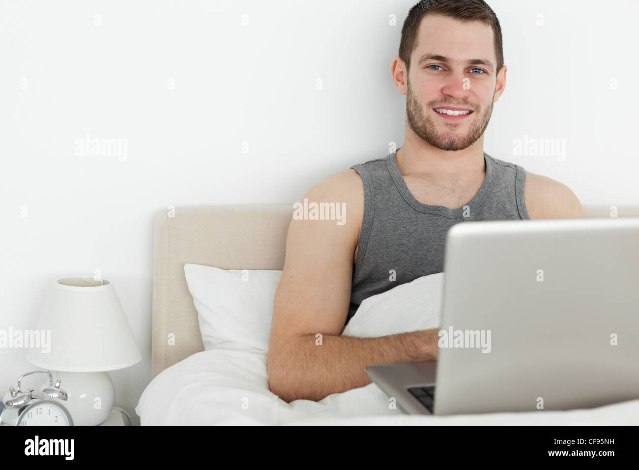 Handsome man using a laptop Stock Photo - Alamy