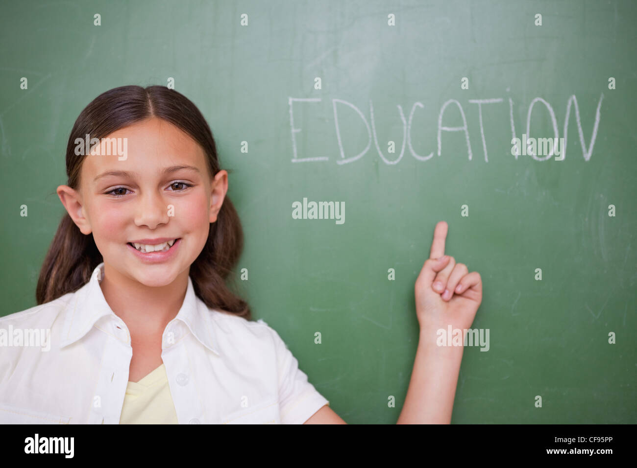 Schoolgirl pointing at a word Stock Photo - Alamy