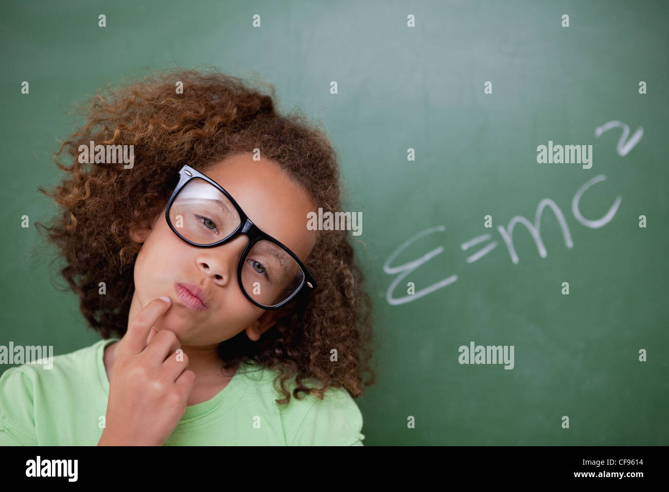 Smart schoolgirl thinking Stock Photo - Alamy