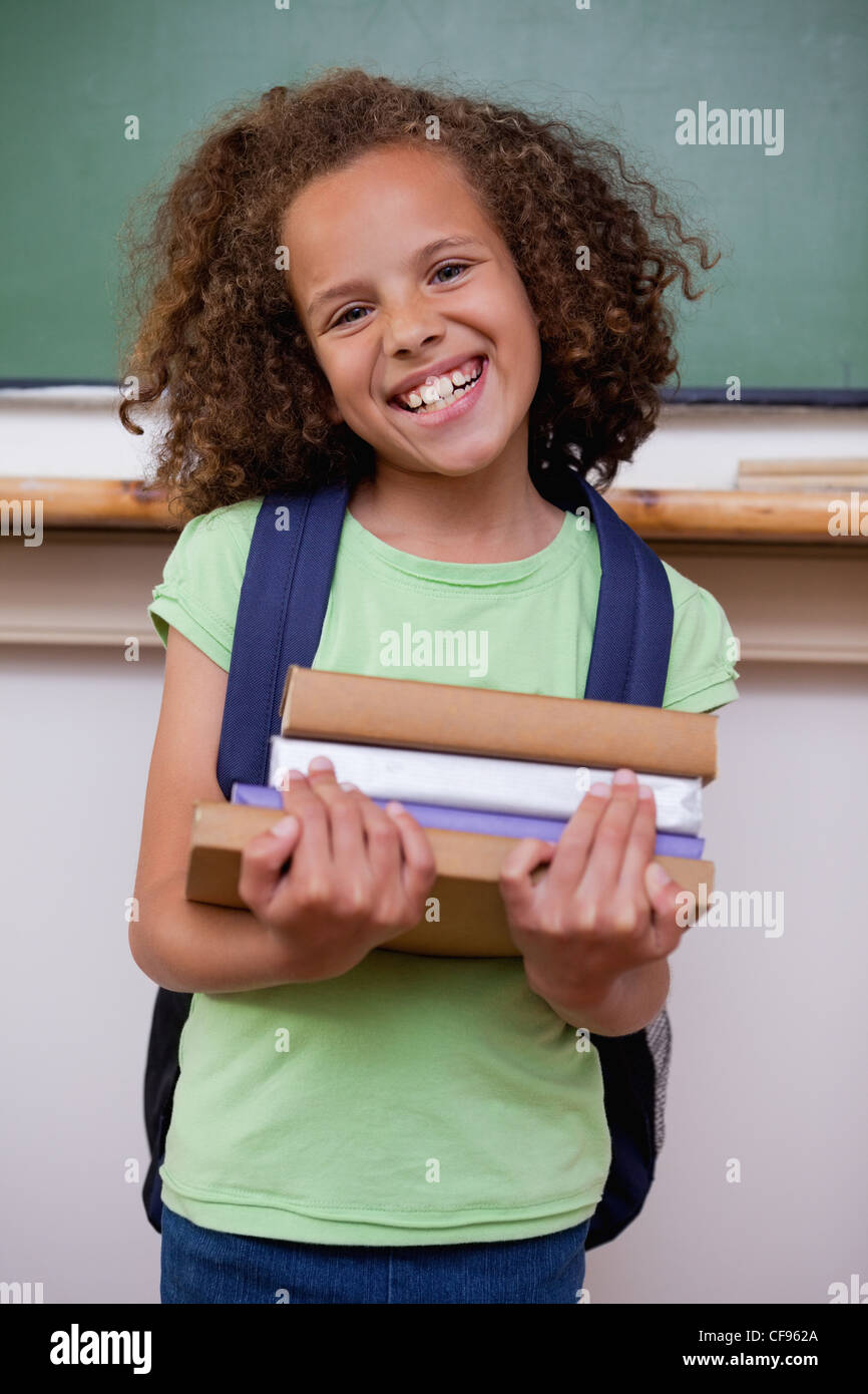 Child carrying books class hi-res stock photography and images - Alamy
