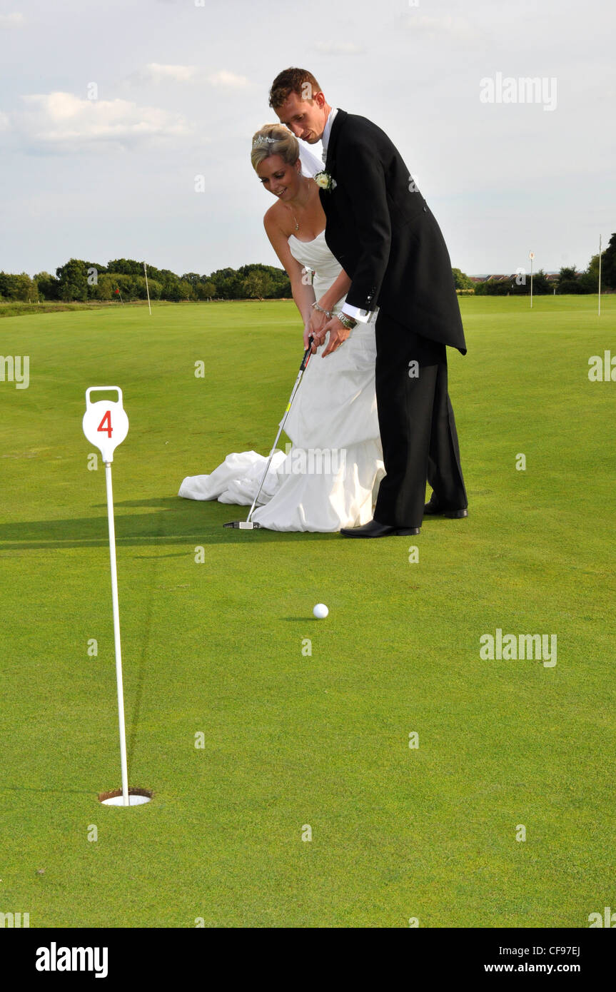 newlyweds playing golf Stock Photo - Alamy