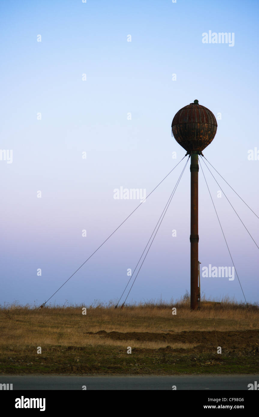 Old rusty water tower in the evening Stock Photo - Alamy