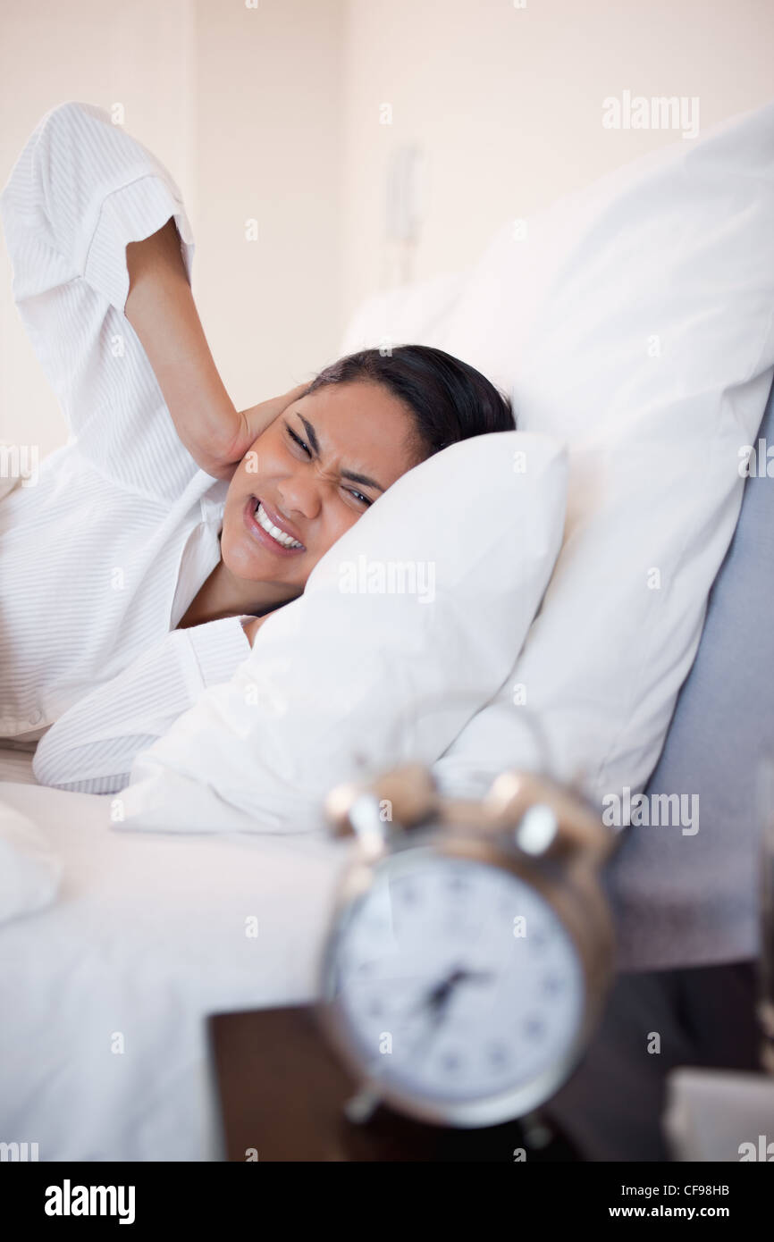 Side view of woman getting ungently woken by alarm clock Stock Photo ...