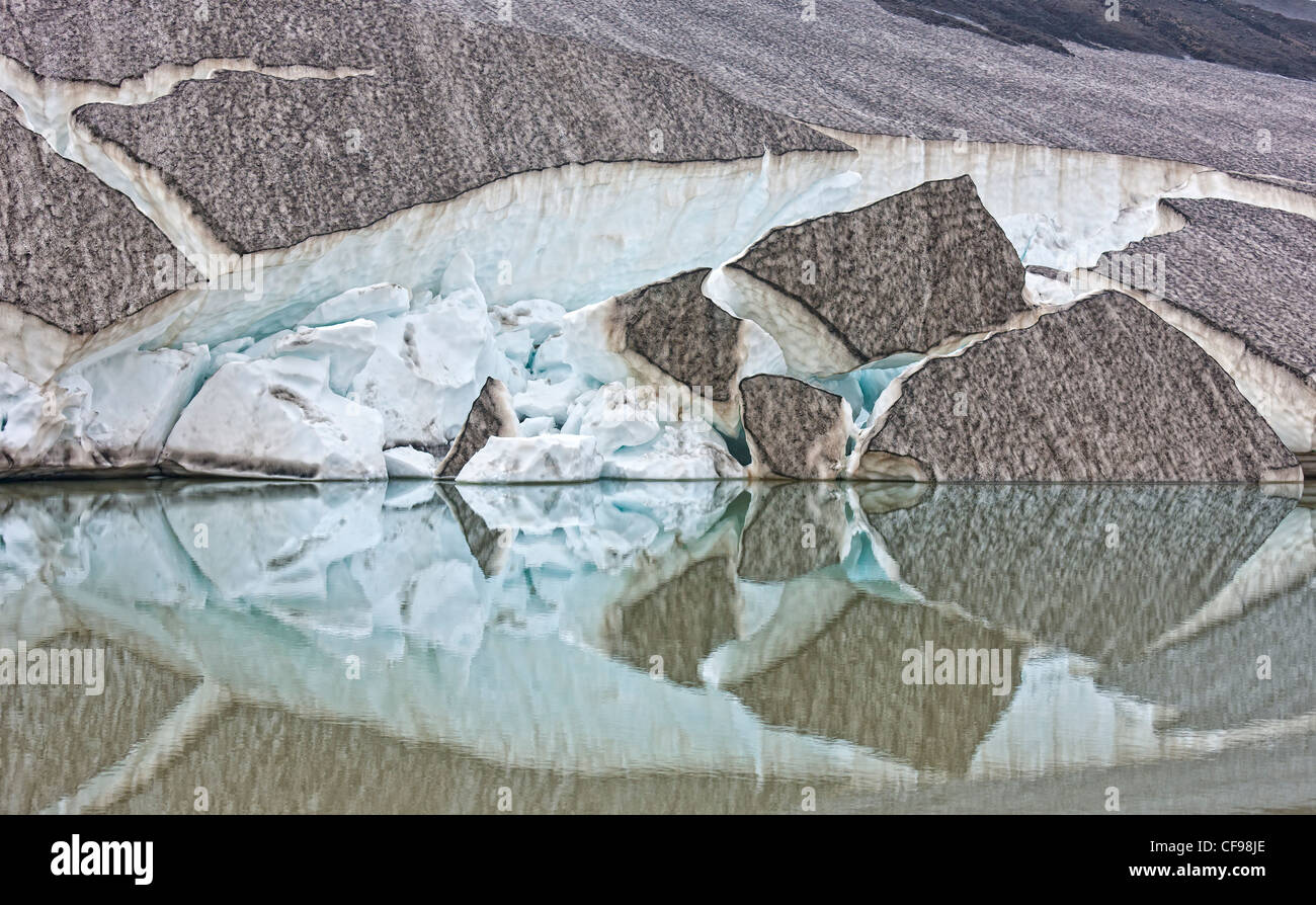 Glacial Ice and reflections in melted water, Iceland Ash from volcanic ...