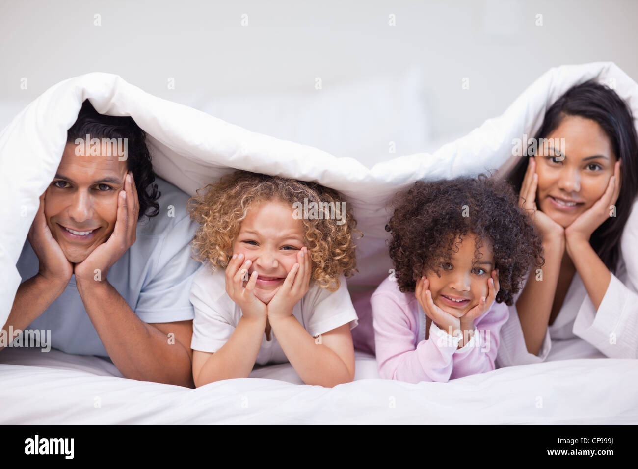 Family hiding under the bed cover Stock Photo - Alamy