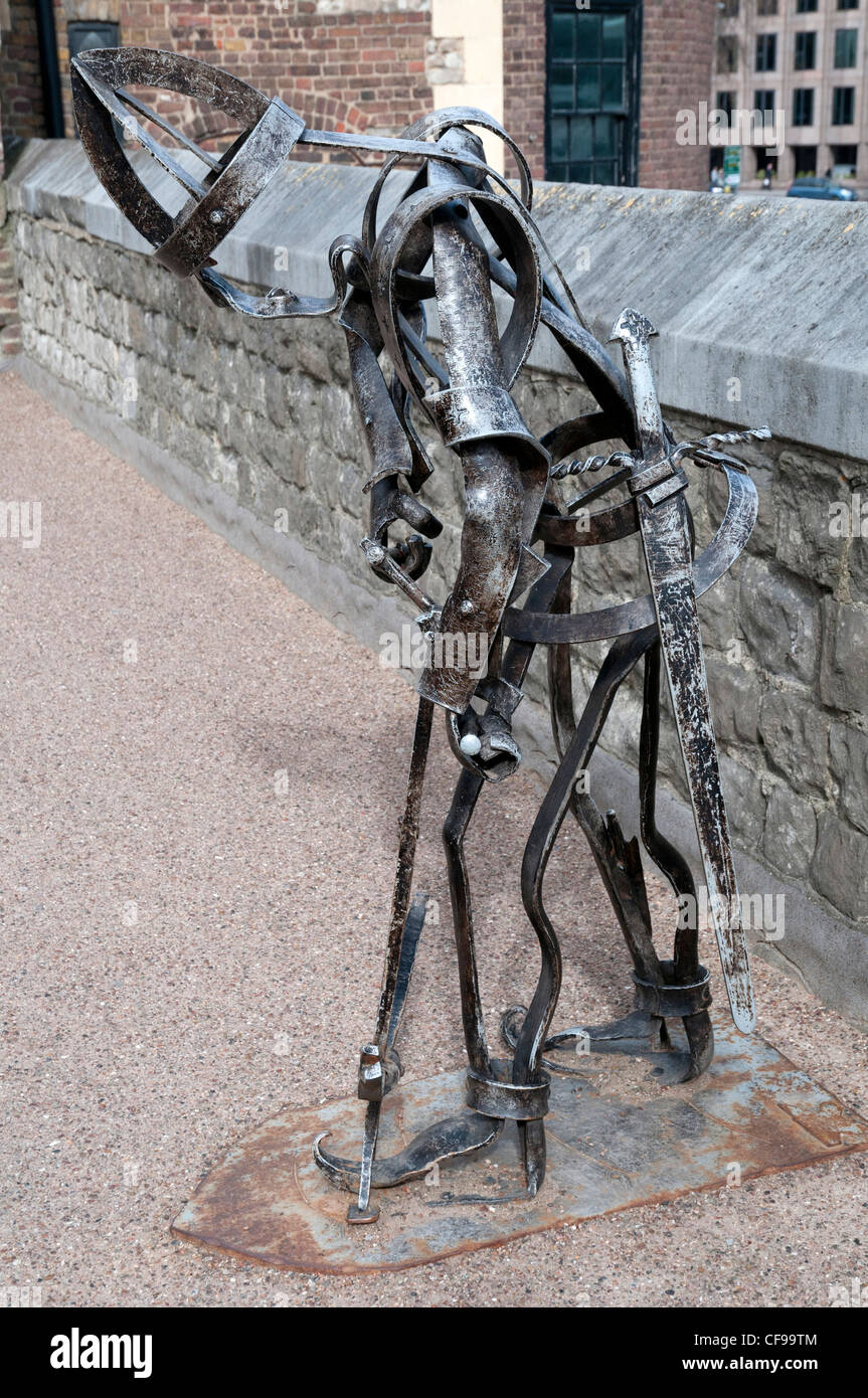 There is a modern artwork, a statue of a crossbowman, a solider with a ...