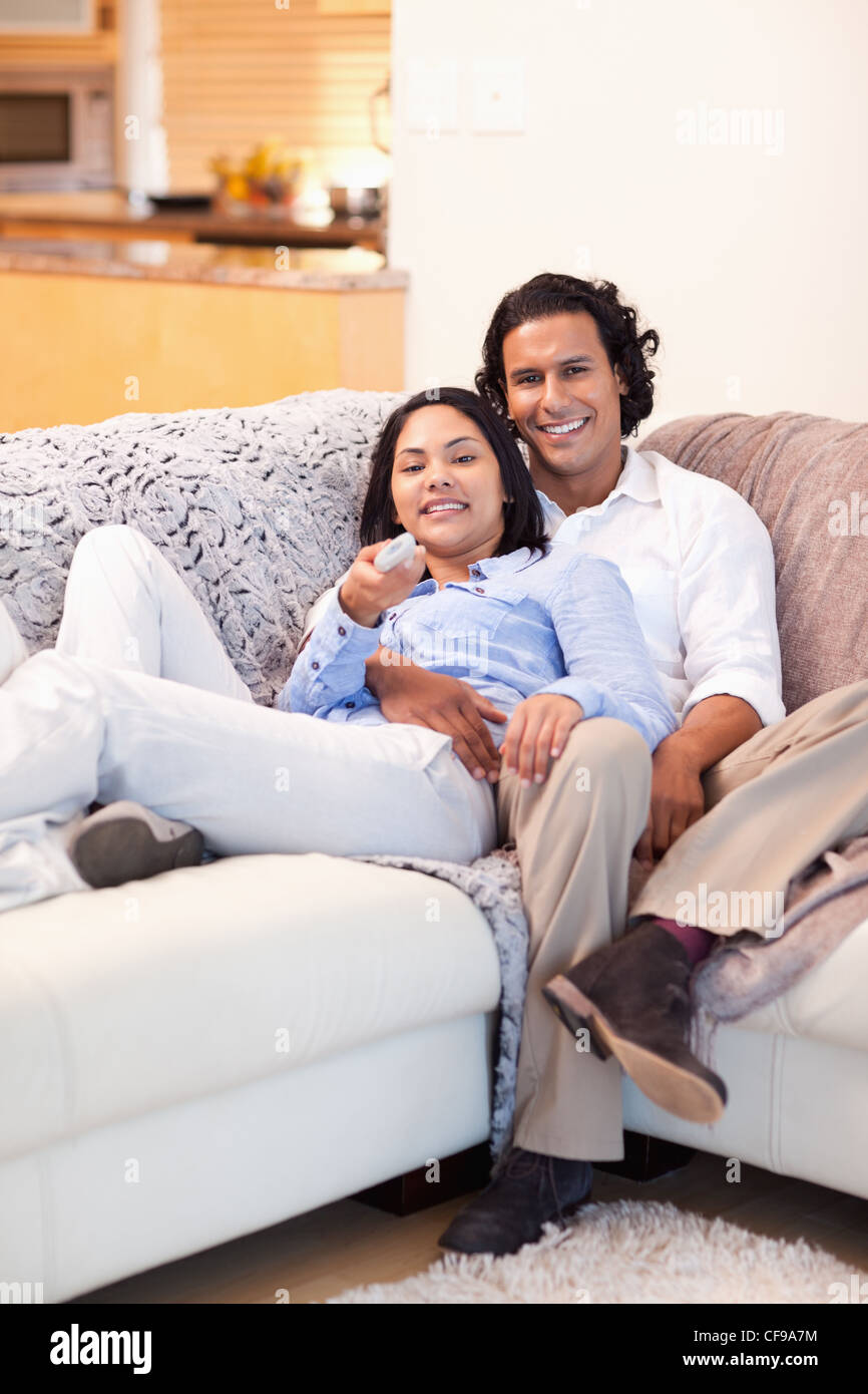 Happy couple watching television together Stock Photo - Alamy