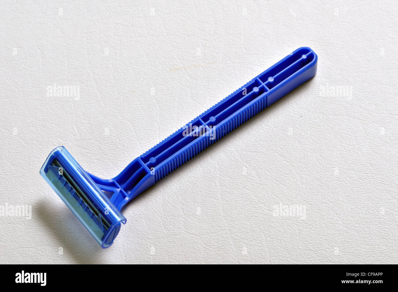 A single disposable razor lays on a plain white background Stock Photo ...