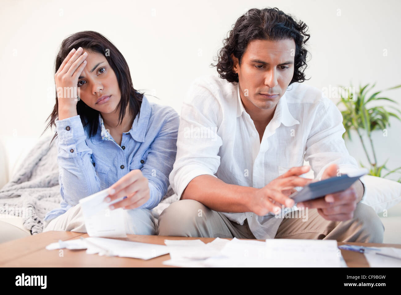 Frustrated couple doing their calculations in the living room Stock ...