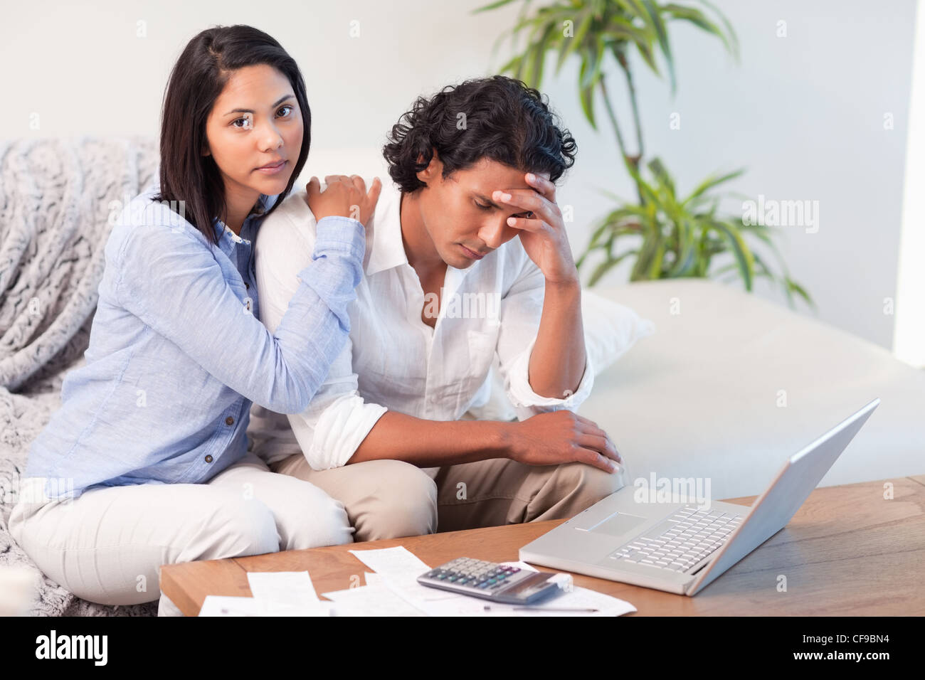 Couple on the sofa doing their calculations Stock Photo - Alamy