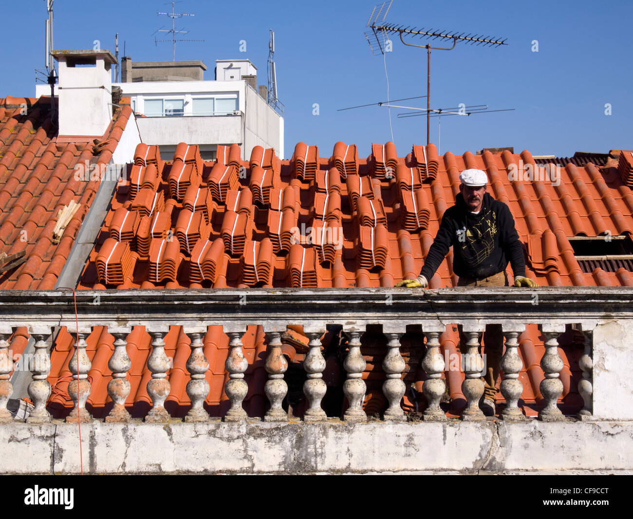 Man on roof Stock Photo - Alamy