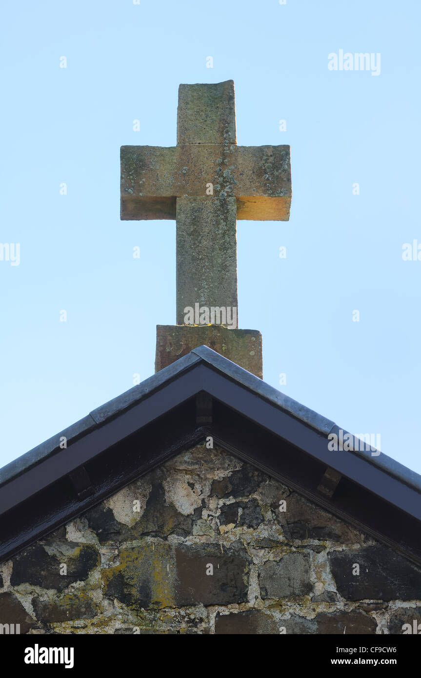 The stone cross sits on top of St Margarets church at the rear of the ...
