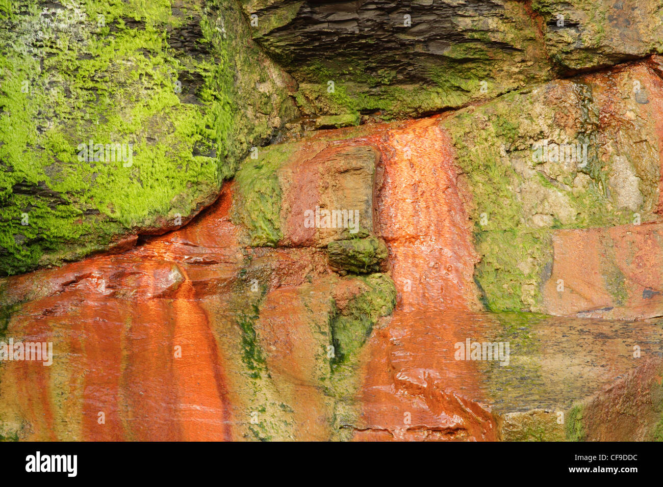 Rock face showing iron being washed out by ground water and staining ...
