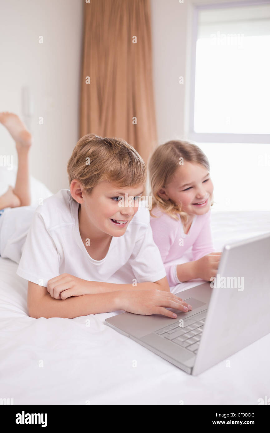 Portrait of children using a notebook Stock Photo - Alamy