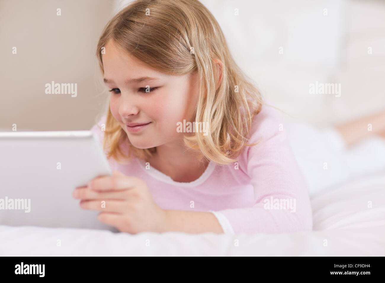 Cute girl using a tablet computer Stock Photo - Alamy