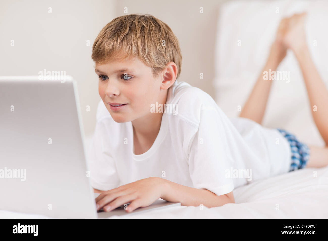 Boy using a notebook Stock Photo - Alamy