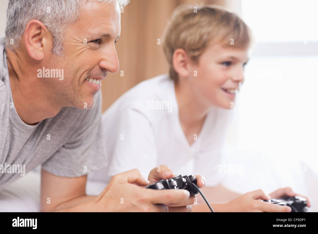 Father and his son playing video games Stock Photo - Alamy