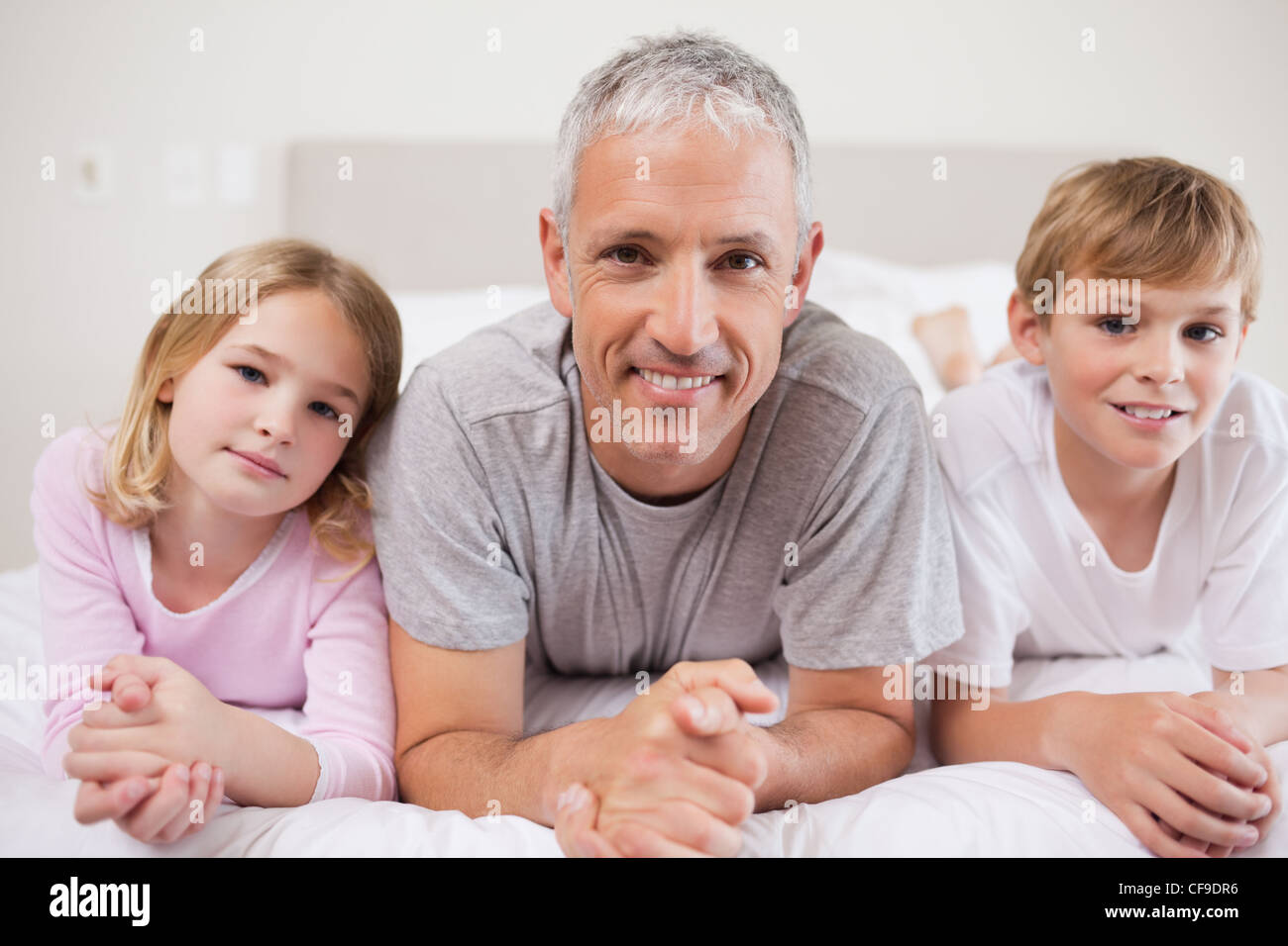 Siblings and their father posing Stock Photo - Alamy