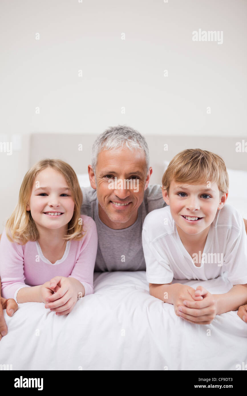Portrait of siblings and their father posing Stock Photo - Alamy