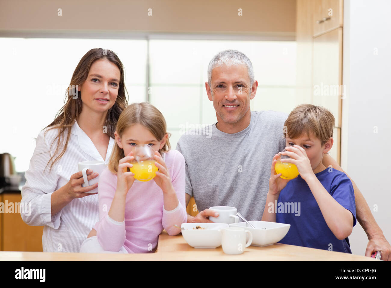 Smiling family having breakfast Stock Photo - Alamy