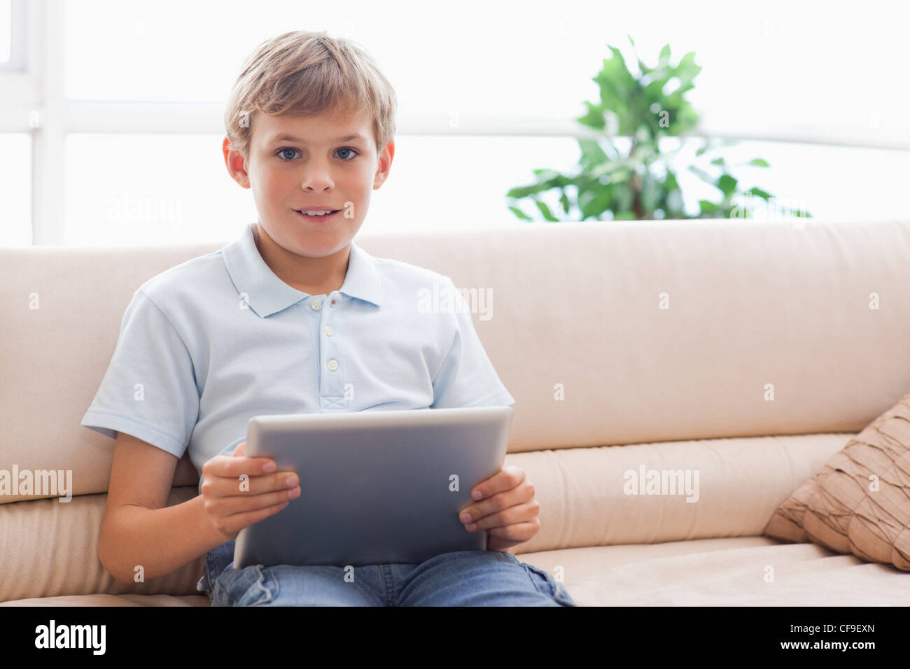Happy boy using tablet computer Stock Photo - Alamy