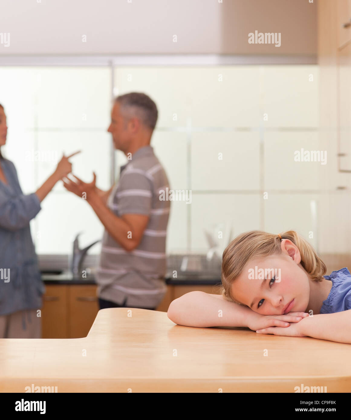 Portrait of a sad girl listening her parents arguing Stock Photo - Alamy