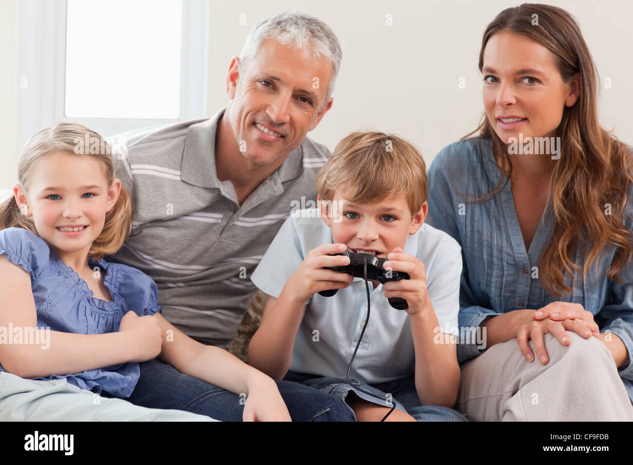 Charming family playing video games Stock Photo - Alamy
