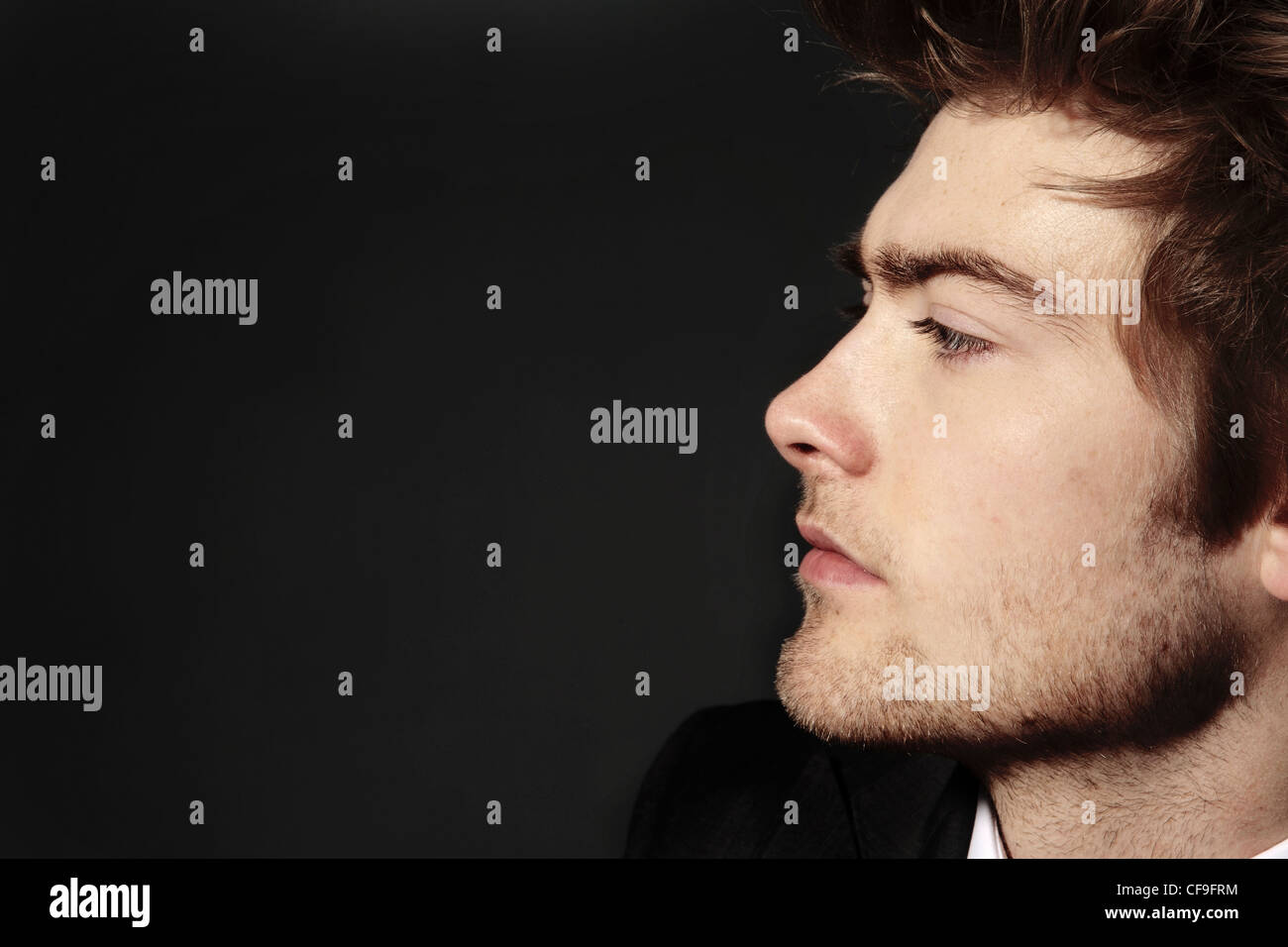 low key image of side profile of a young man Stock Photo - Alamy
