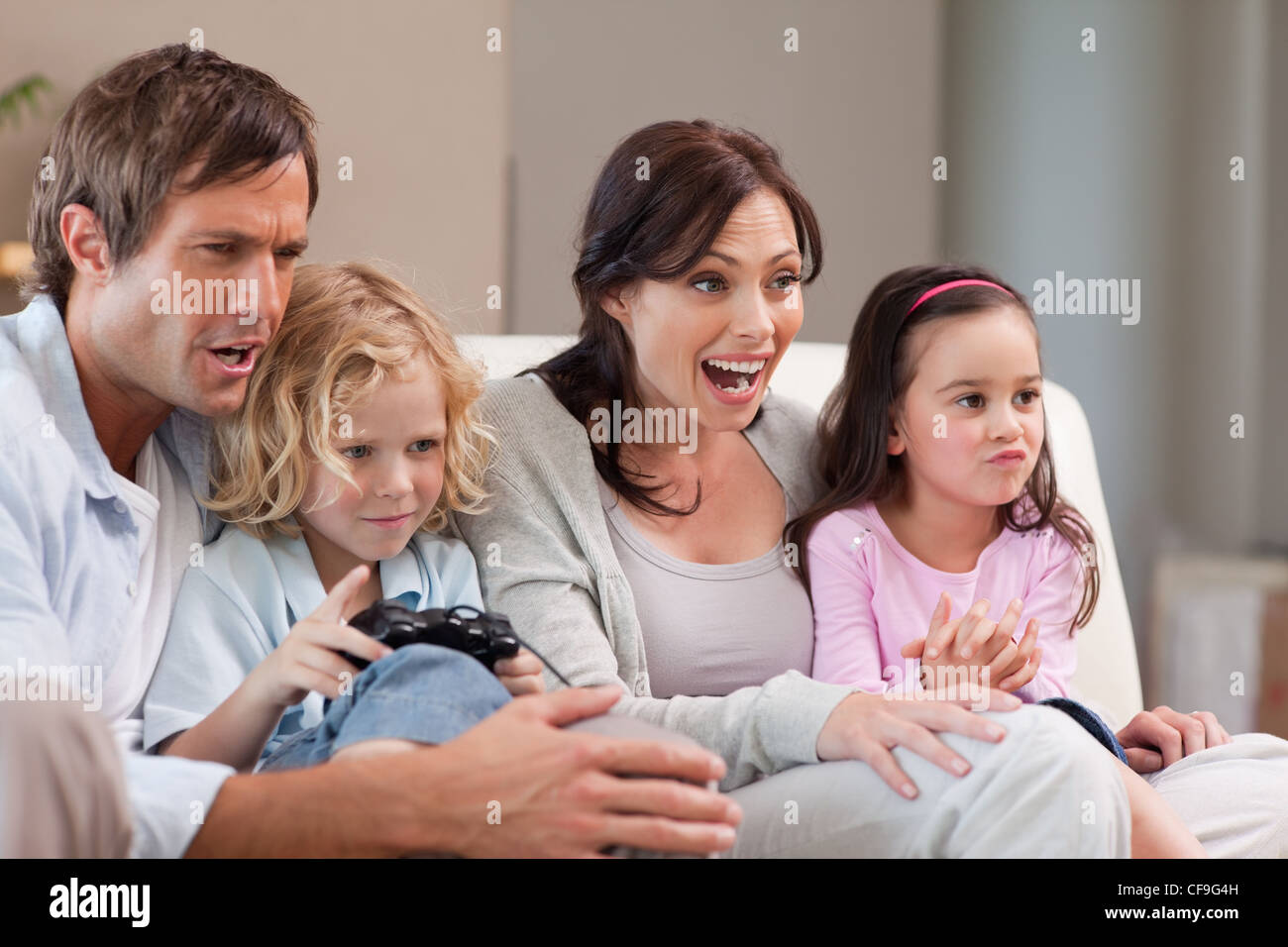 Cheerful family playing video games together Stock Photo - Alamy