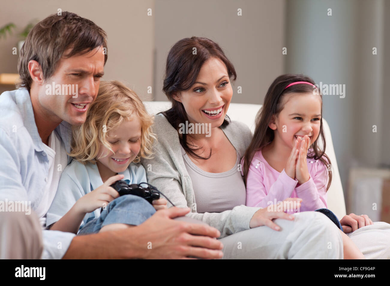 Happy family playing video games together Stock Photo - Alamy