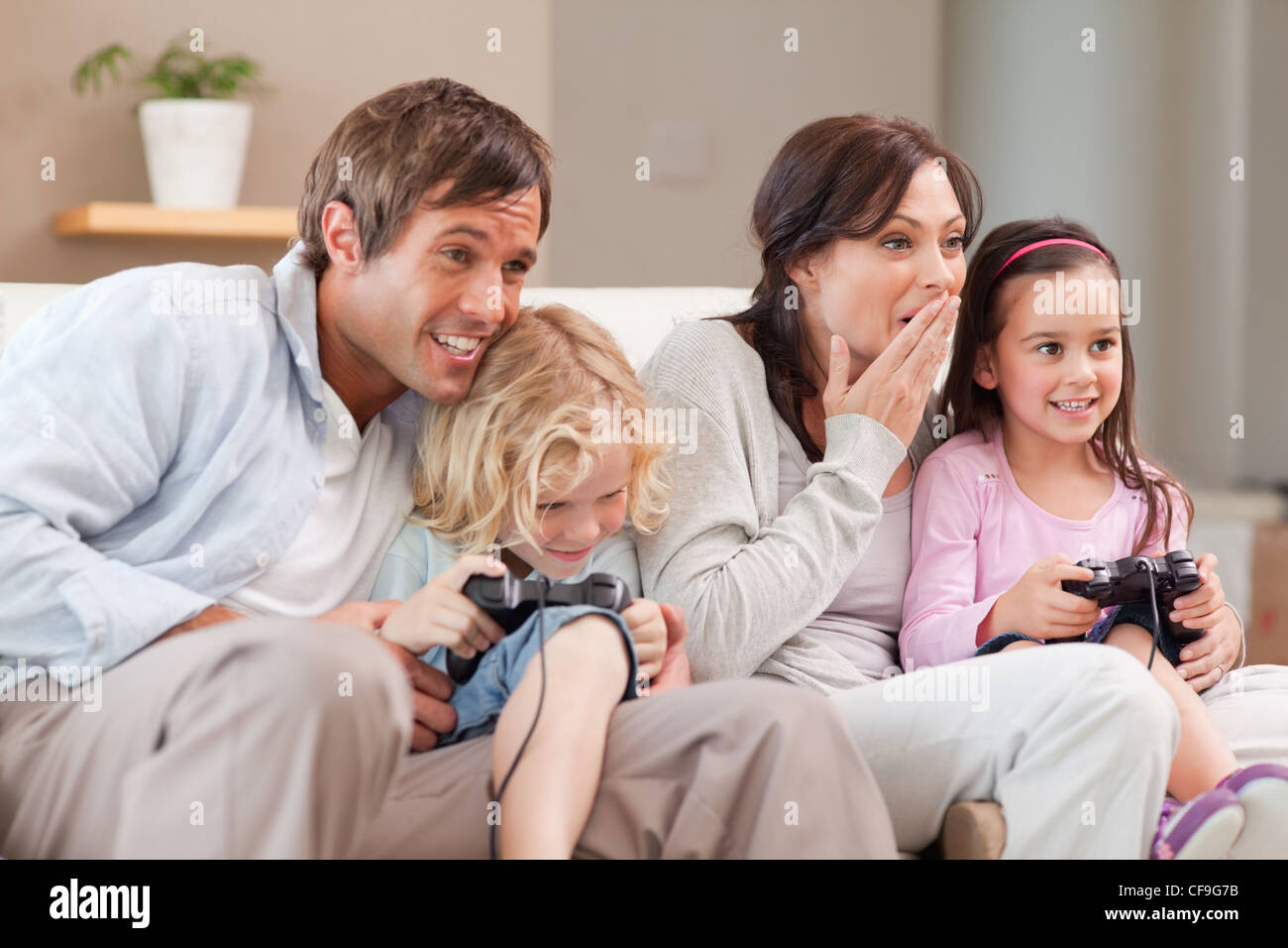 Competitive family playing video games Stock Photo - Alamy