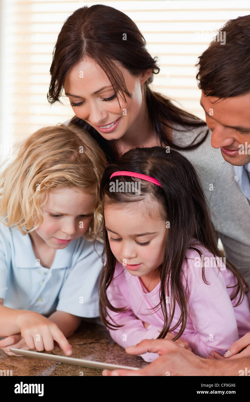 Portrait of a family using a tablet computer together Stock Photo - Alamy