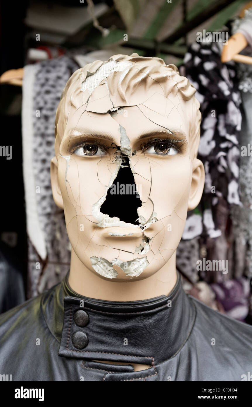 mannequin with a smashed face outside a clothes shop wearing a leather ...