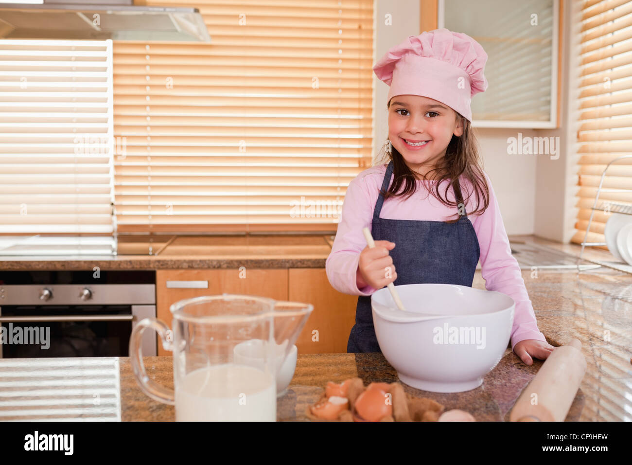 Cute girl baking Stock Photo - Alamy