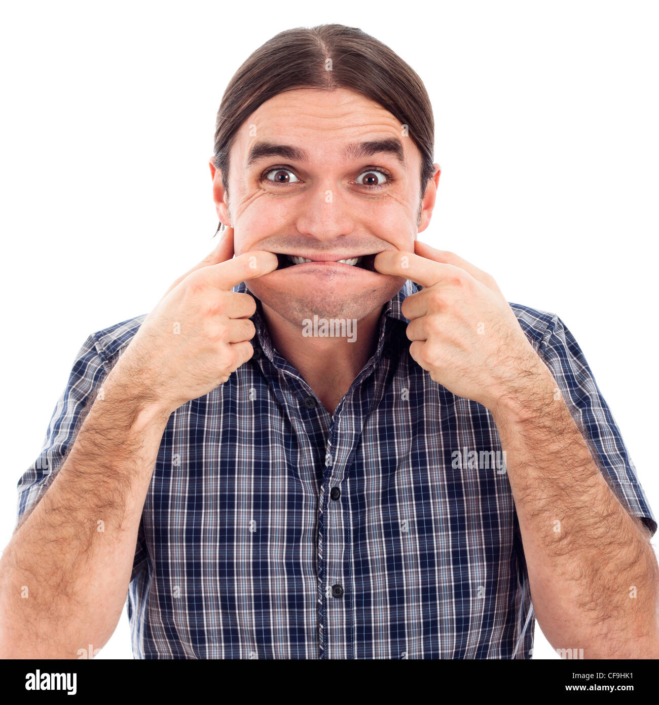 Portrait of young man making funny faces, isolated on white background ...