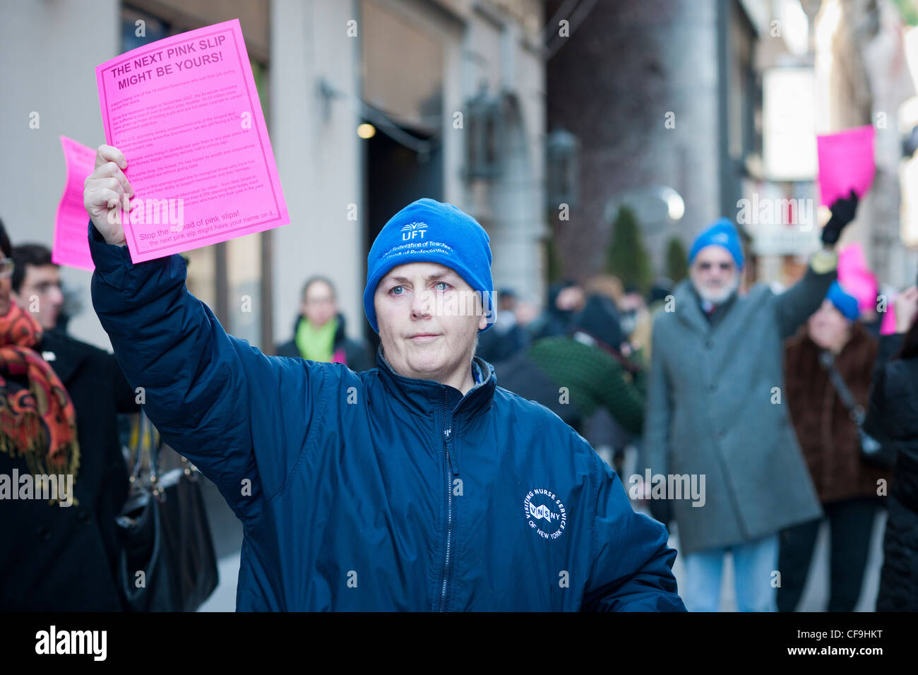 Hundreds of volunteers holding symbolic "pink slips" line Broadway in ...