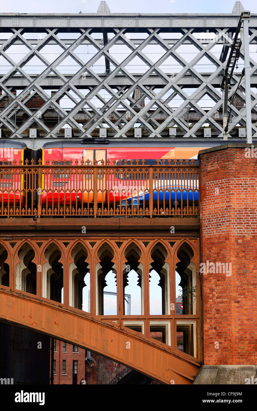 Train passing over Victorian built viaduct in the Castlefields area of ...