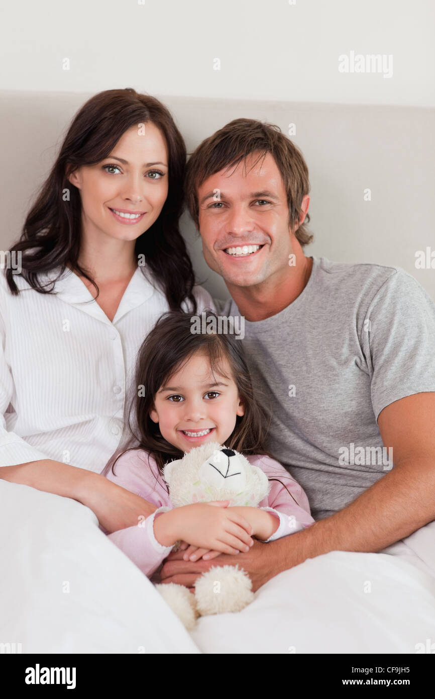 Portrait of parents posing with their daughter Stock Photo - Alamy